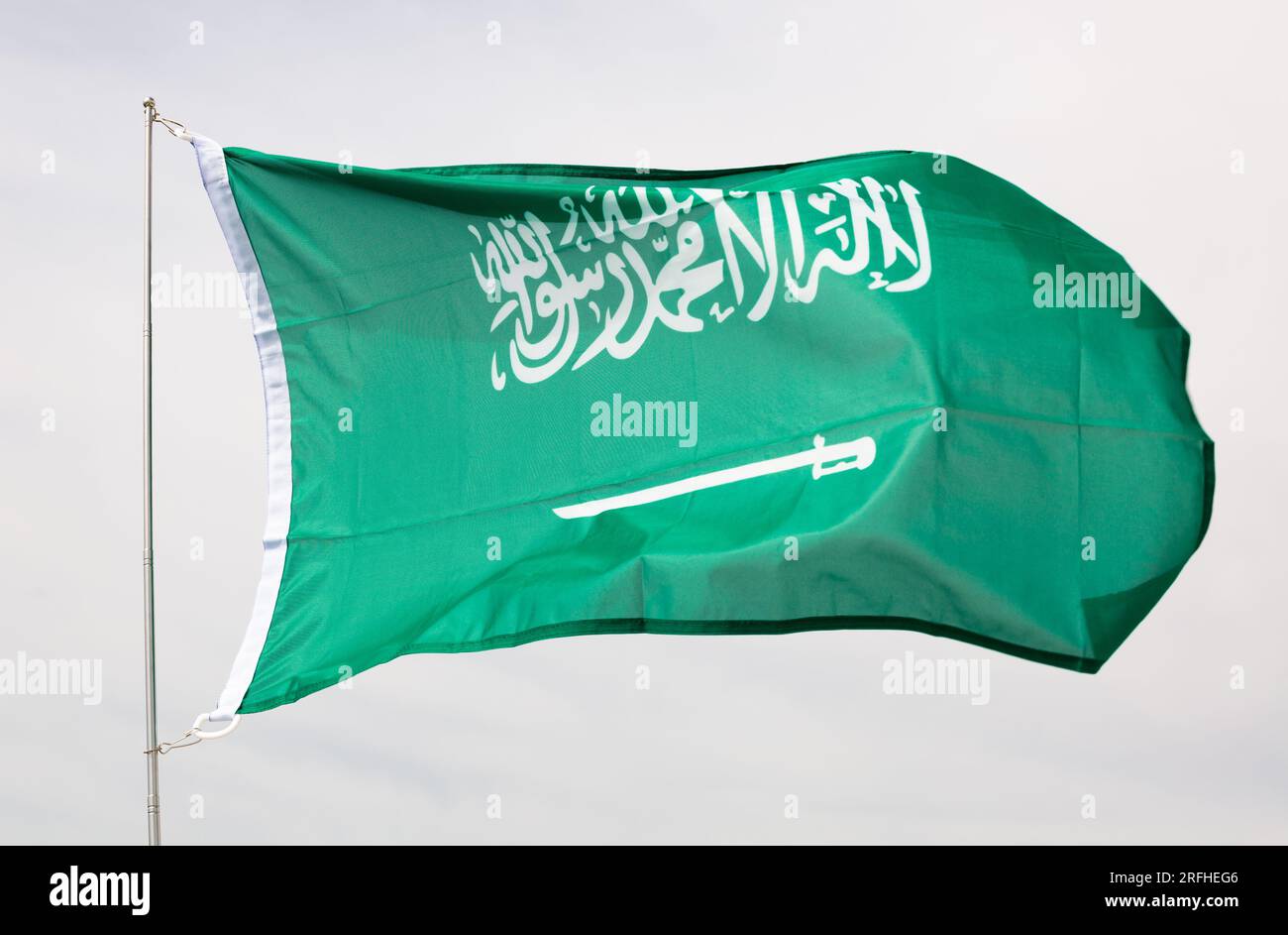 Flag of Saudi Arabia waving on flagstaff against cloudy sky Stock Photo ...
