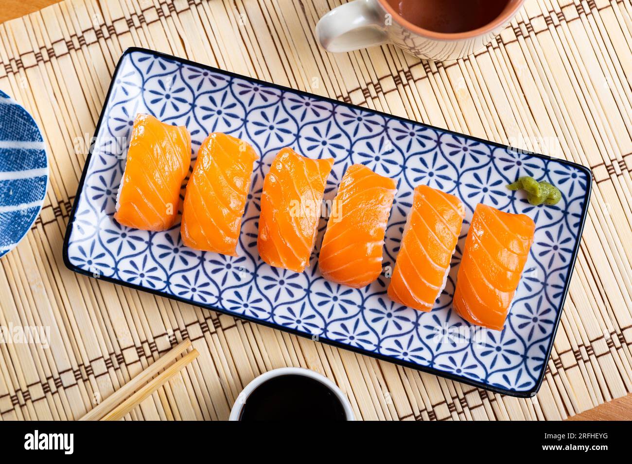 Sake nigiri - dietary sushi with salmon and tuna, soy sauce closeup ...