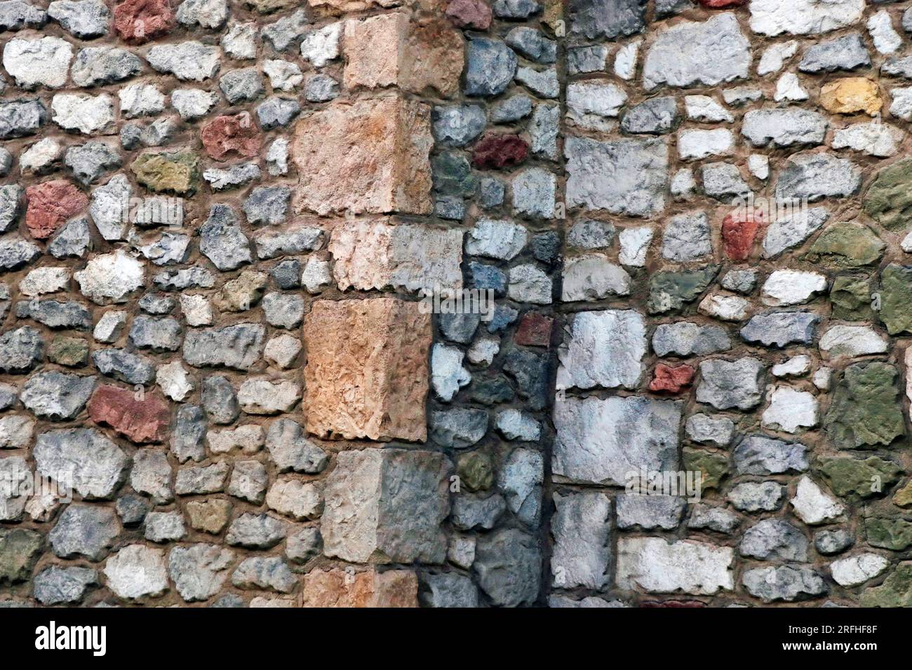 colorful and solid stone worked house walls in close up Stock Photo - Alamy