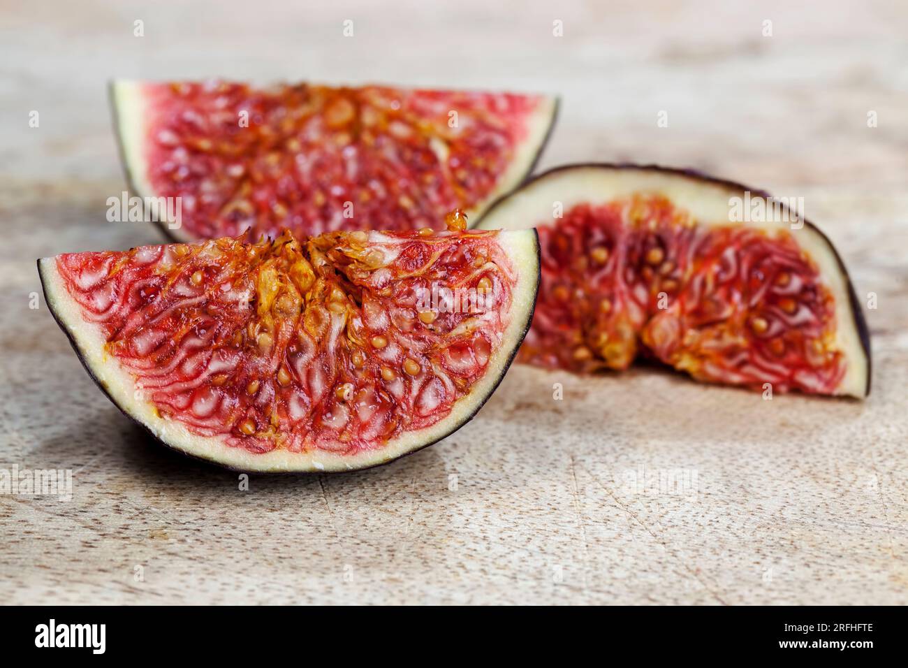 ripe figs cut into pieces, red fig pulp with lots of seeds, part of fig ...