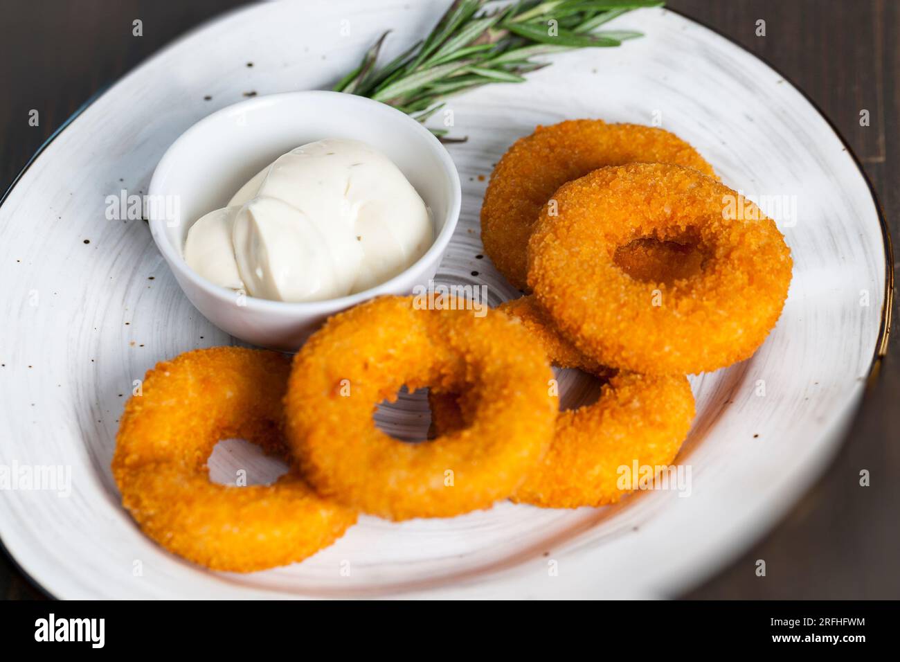 deep fried cheese rings in a cafe, cheese rings with cheese sauce with ...