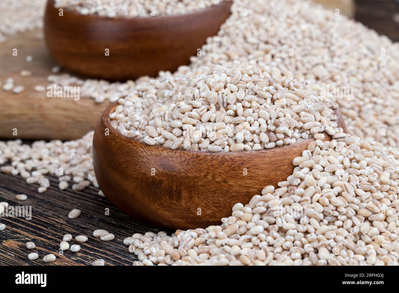 pearl barley for cooking porridge, cereals are scattered in dishes on ...