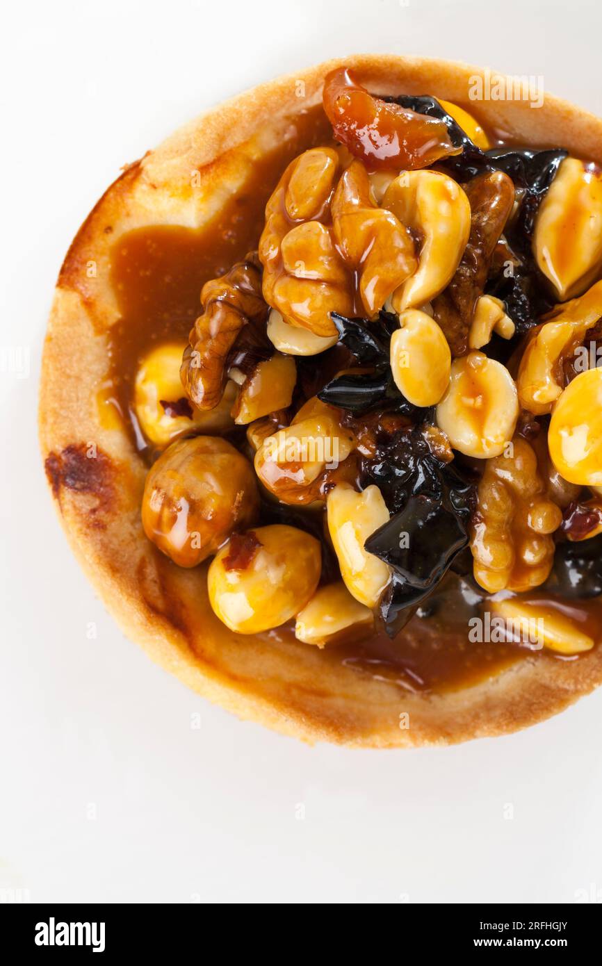 nut tartlets covered with a layer of sugar caramel, dessert of dough ...