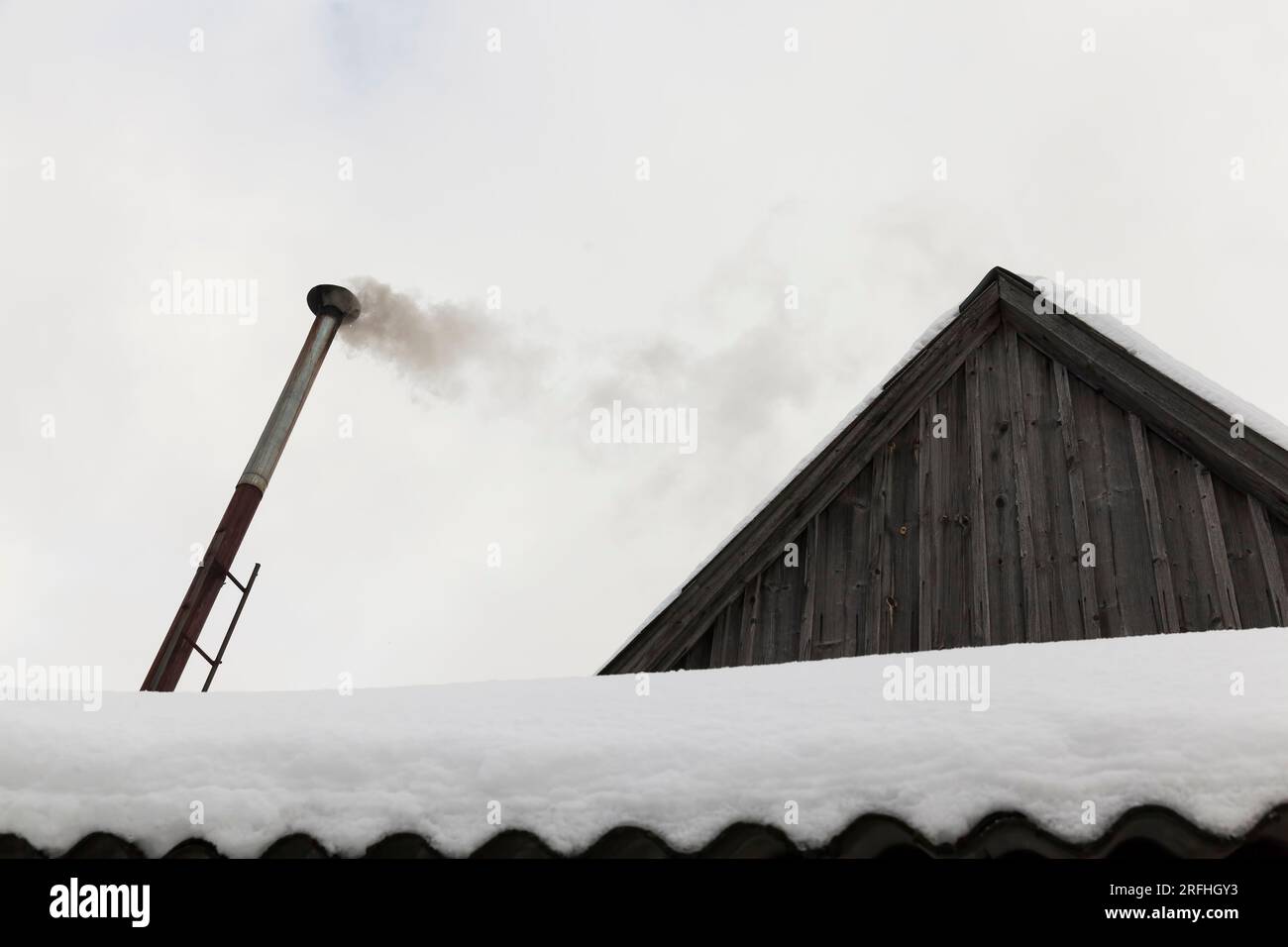 chimneys and chimneys on the roof of a building in winter, the roof and ...