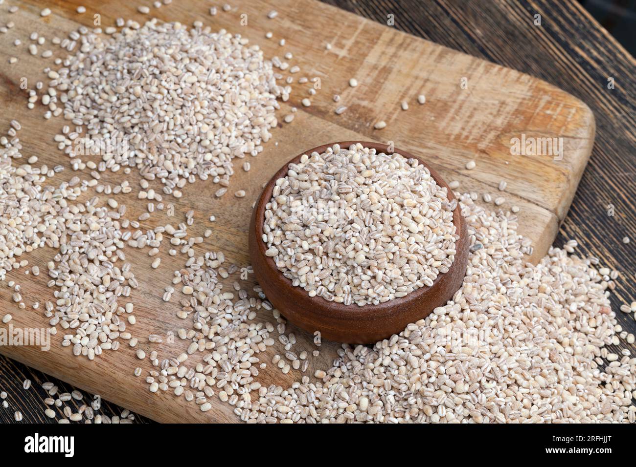 pearl barley for cooking porridge, cereals are scattered in dishes on ...