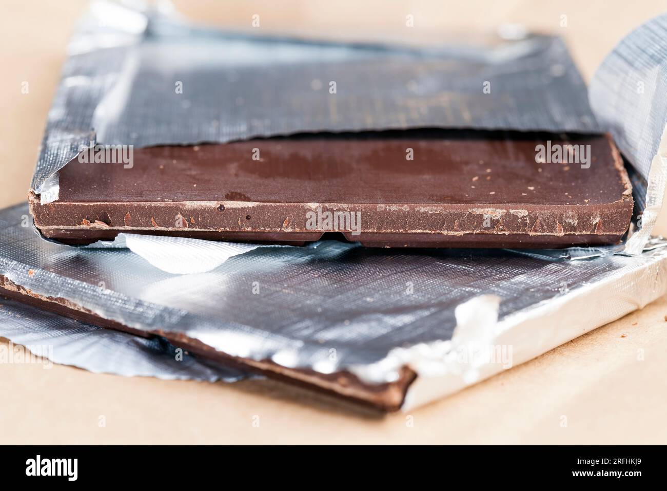 an old chocolate bar on which there are traces of human hands, a ...