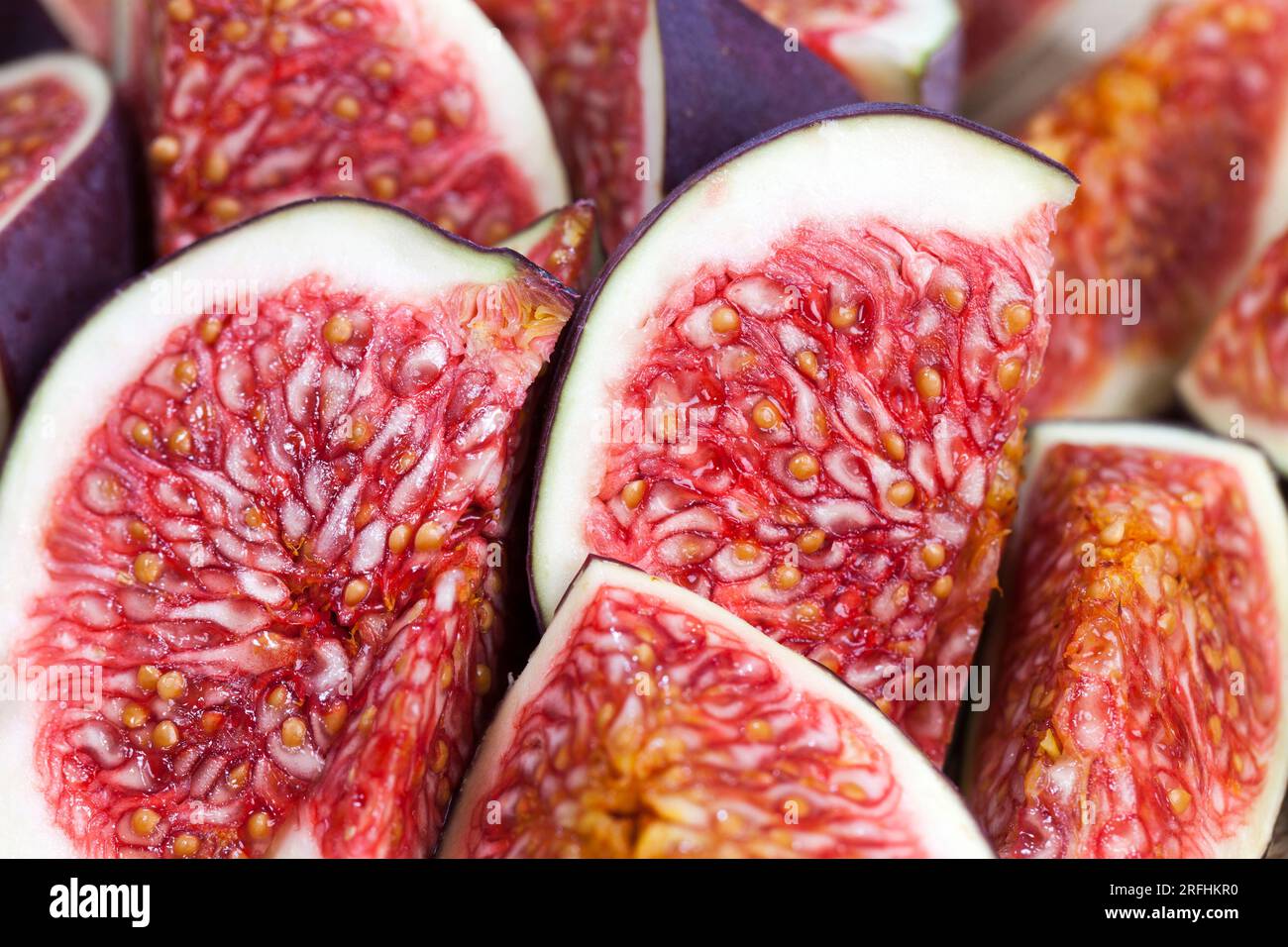 ripe figs cut into pieces, red fig pulp with lots of seeds, part of fig ...