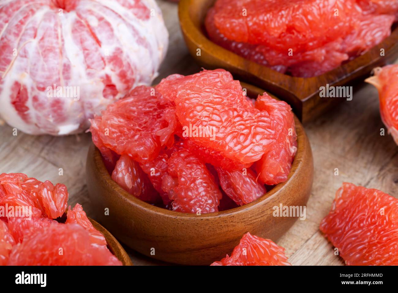 peeled pink grapefruit split into pieces while cooking, ready to eat ...