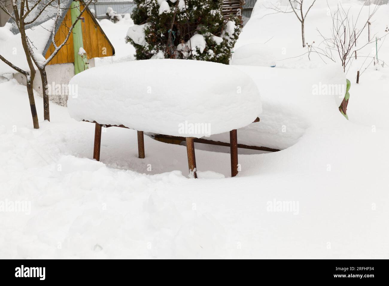 objects covered with a thick layer of snow on the street in winter ...