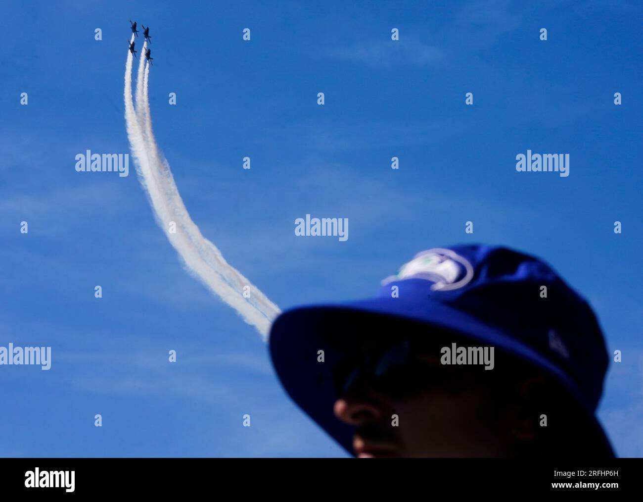 U.S. Navy Blue Angels pass by on a practice flight as fan Joe Simpson ...