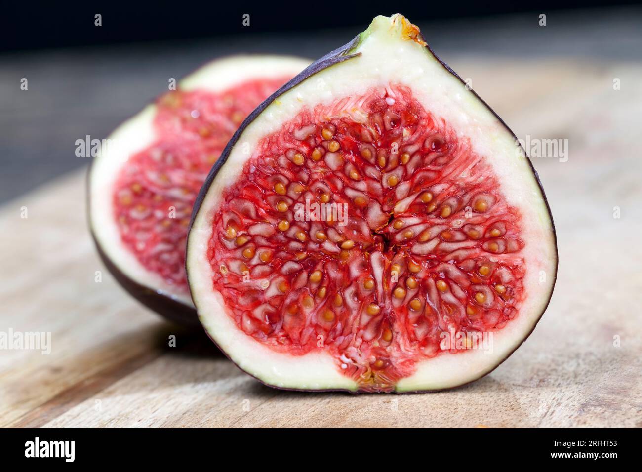ripe figs cut into pieces, red fig pulp with lots of seeds, part of fig ...