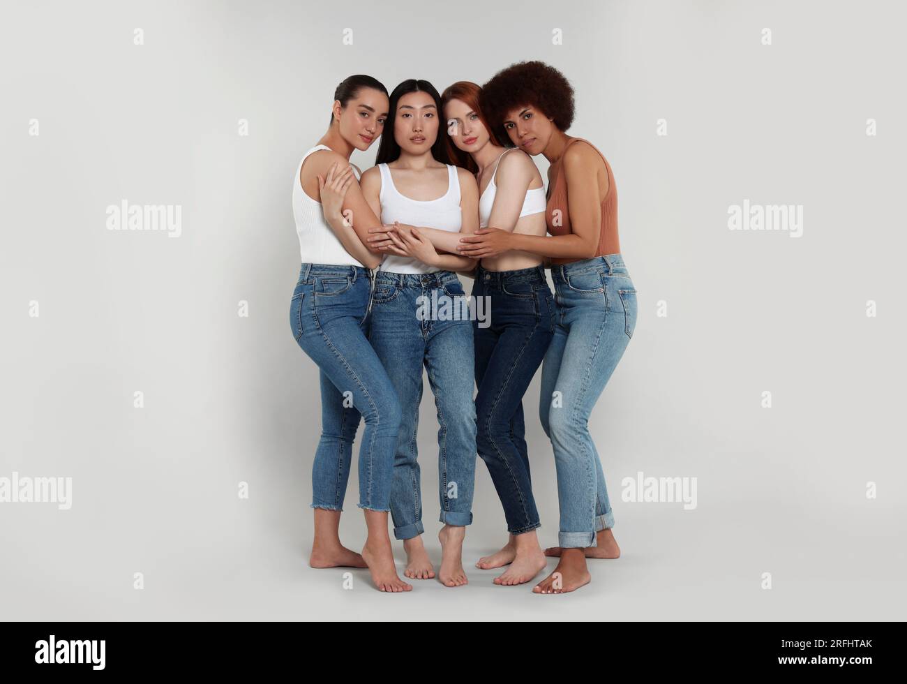 Group of beautiful young women on light grey background Stock Photo - Alamy