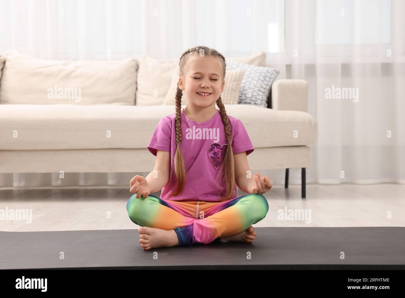 Little girl meditating at home. Harmony and zen Stock Photo - Alamy