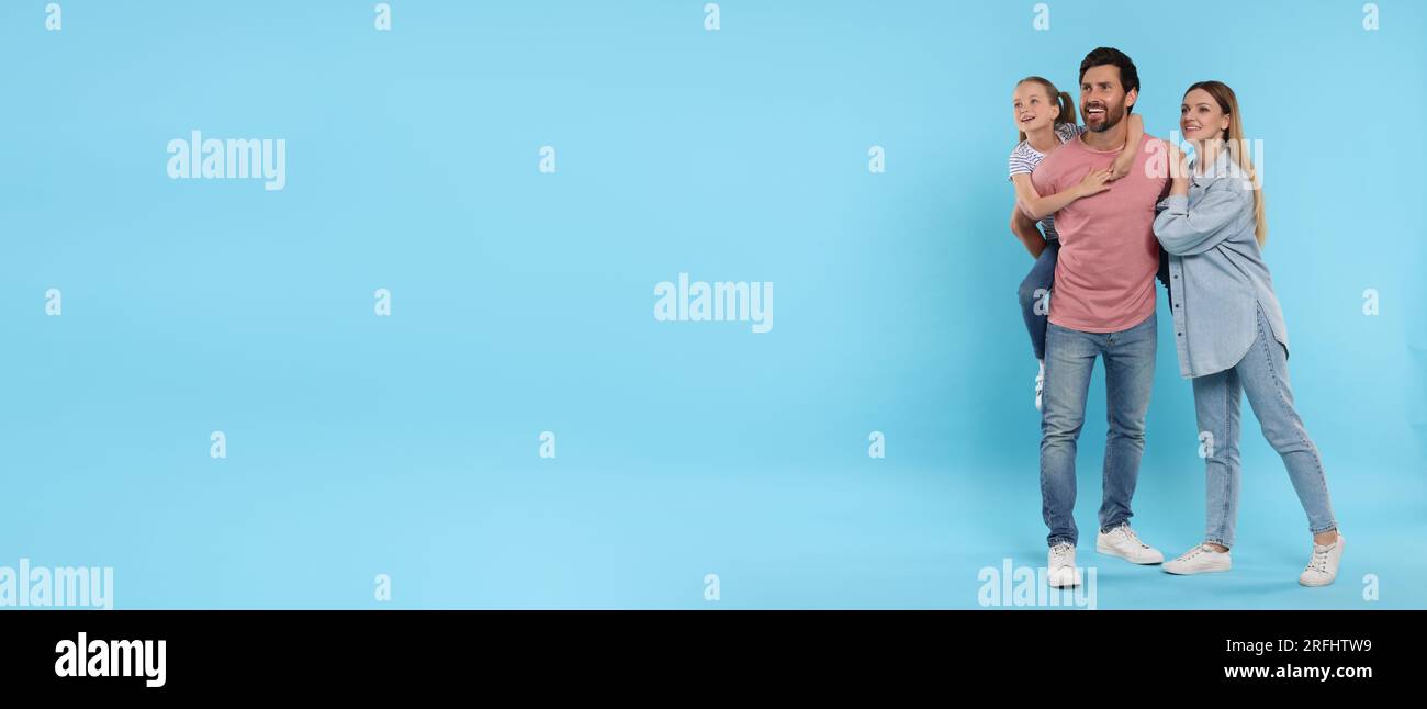 Happy family with child on light blue background, space for text ...