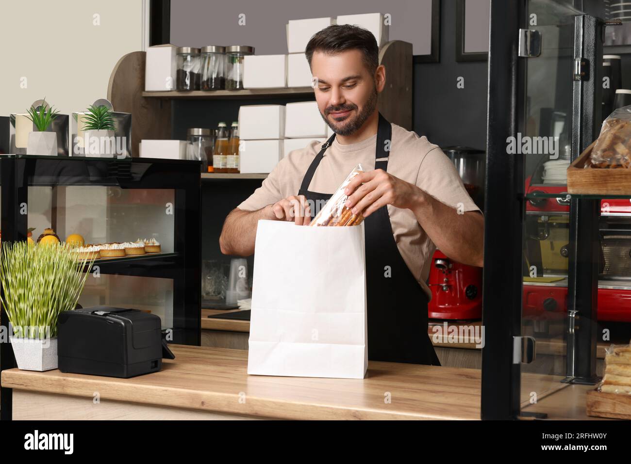 Male bakery owner packing hi-res stock photography and images - Alamy