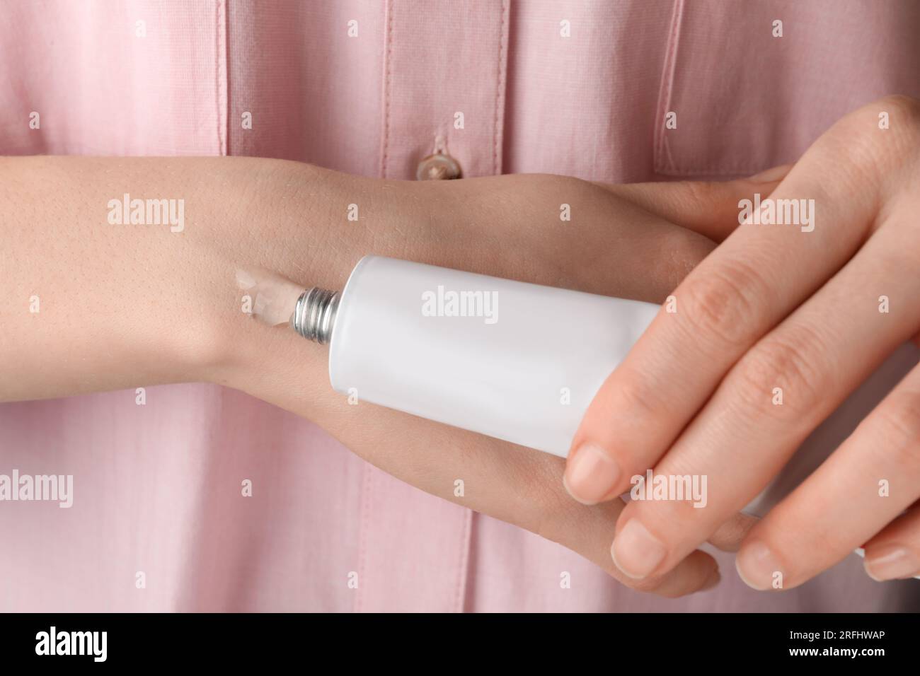 Woman squeezing out ointment from tube on her hand, closeup Stock Photo ...