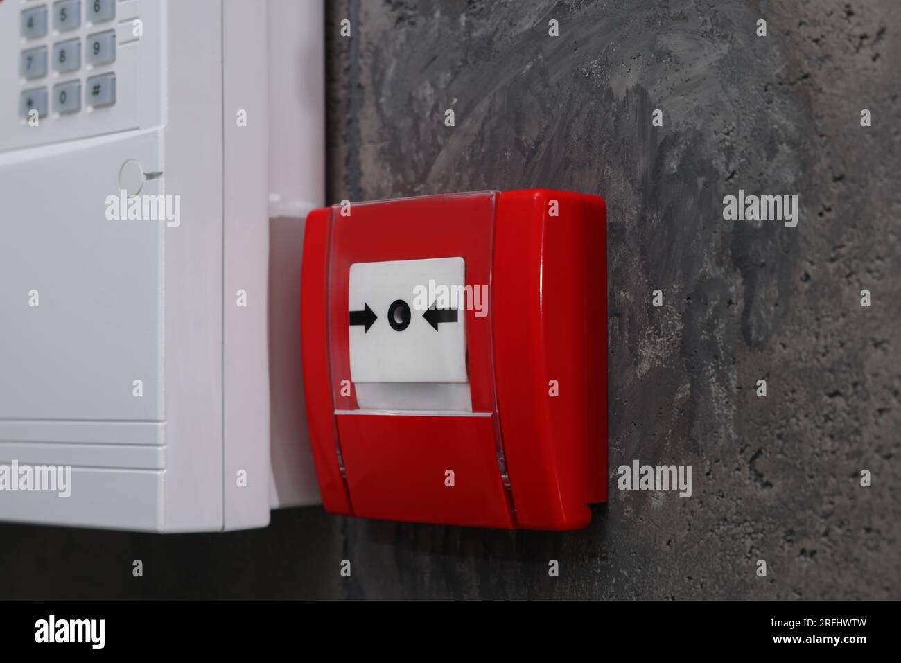 Fire alarm push button on grey wall Stock Photo - Alamy