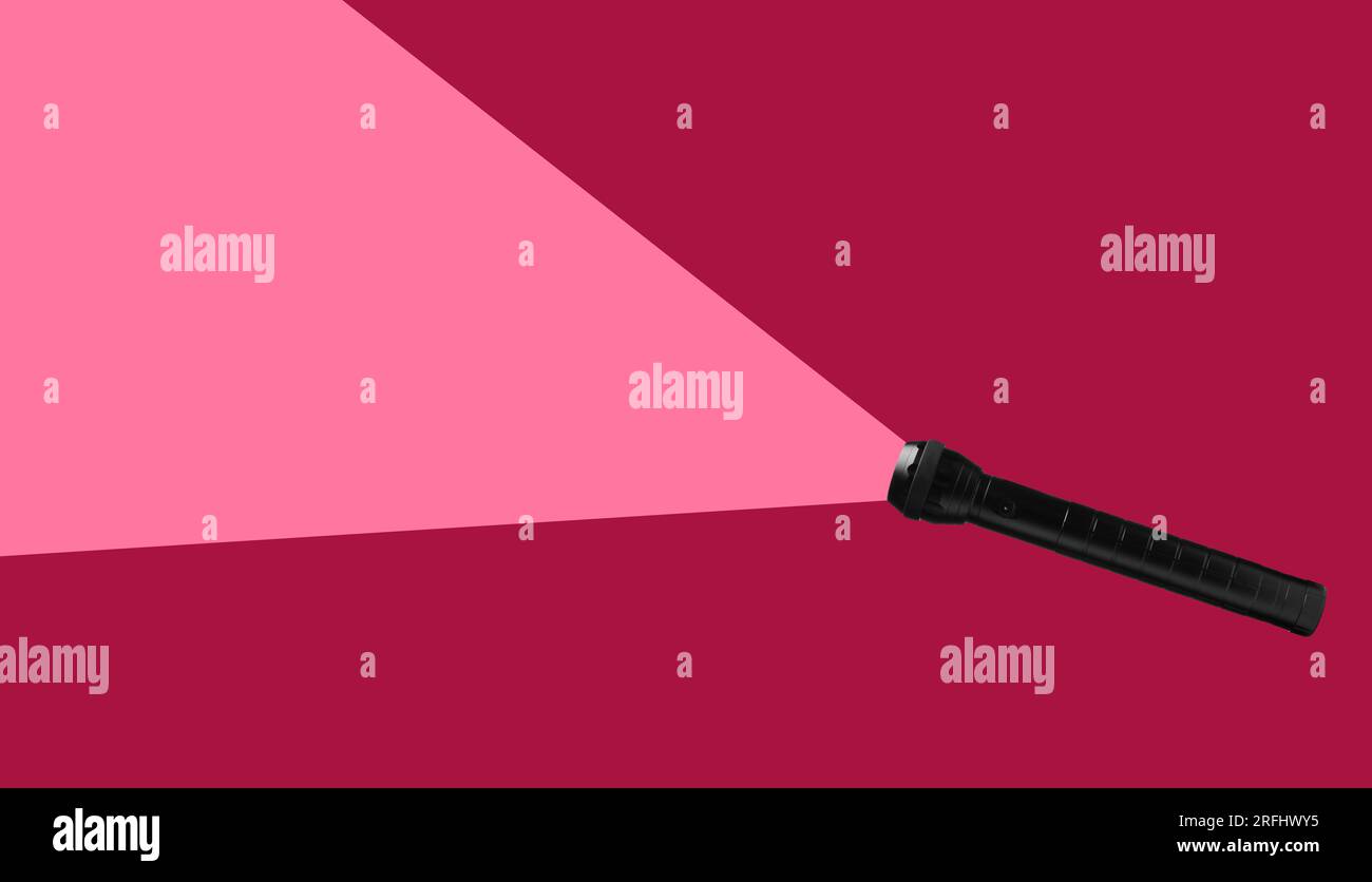 Flashlight illuminating pink background. Light symbolizing search ...