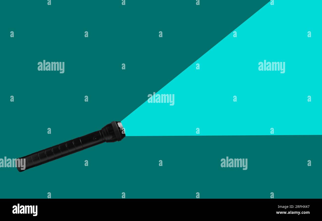 Flashlight illuminating turquoise background. Light symbolizing search ...