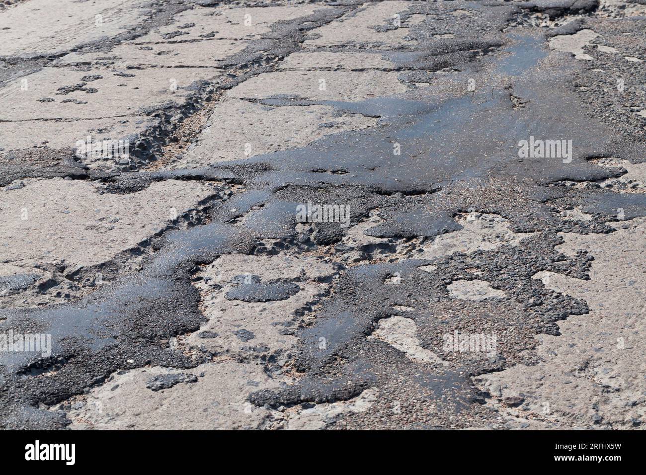 a road of poor quality has been repaired many times, a bad road with ...