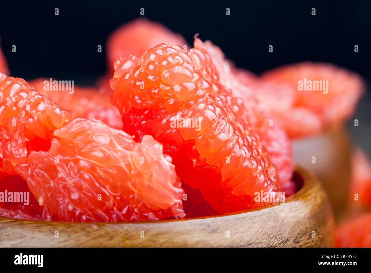 peeled pink grapefruit split into pieces while cooking, ready to eat ...