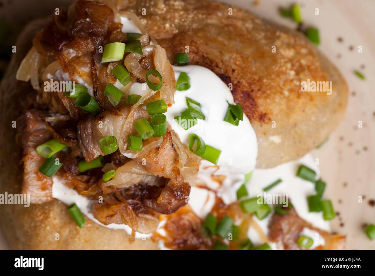 a traditional Lithuanian dish served with sour cream and fried bacon ...