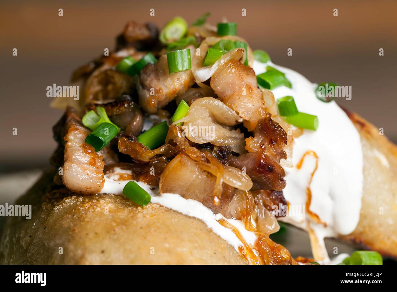 a traditional Lithuanian dish served with sour cream and fried bacon ...