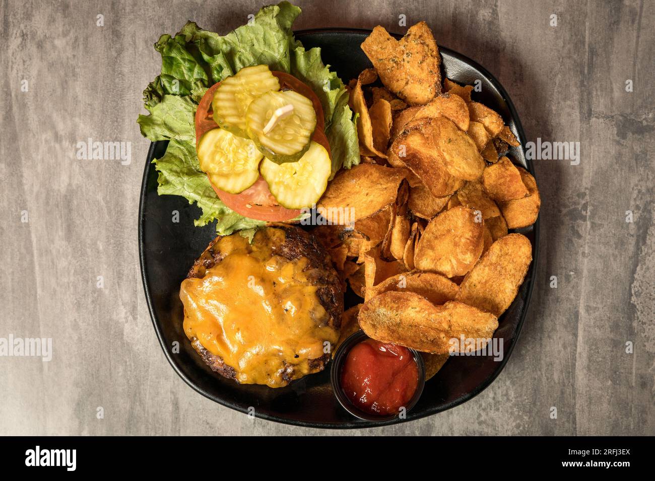 Cheeseburger with potato chips Stock Photo - Alamy