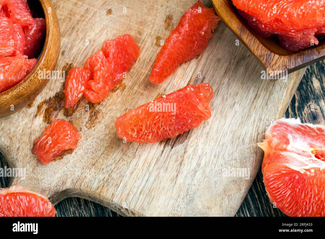 peeled pink grapefruit split into pieces while cooking, ready to eat ...