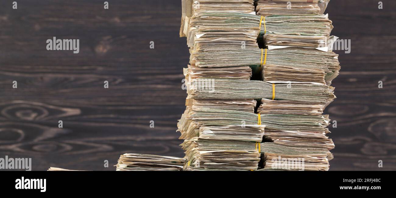 a large amount of old crumpled and dirty money, stacked in huge piles ...