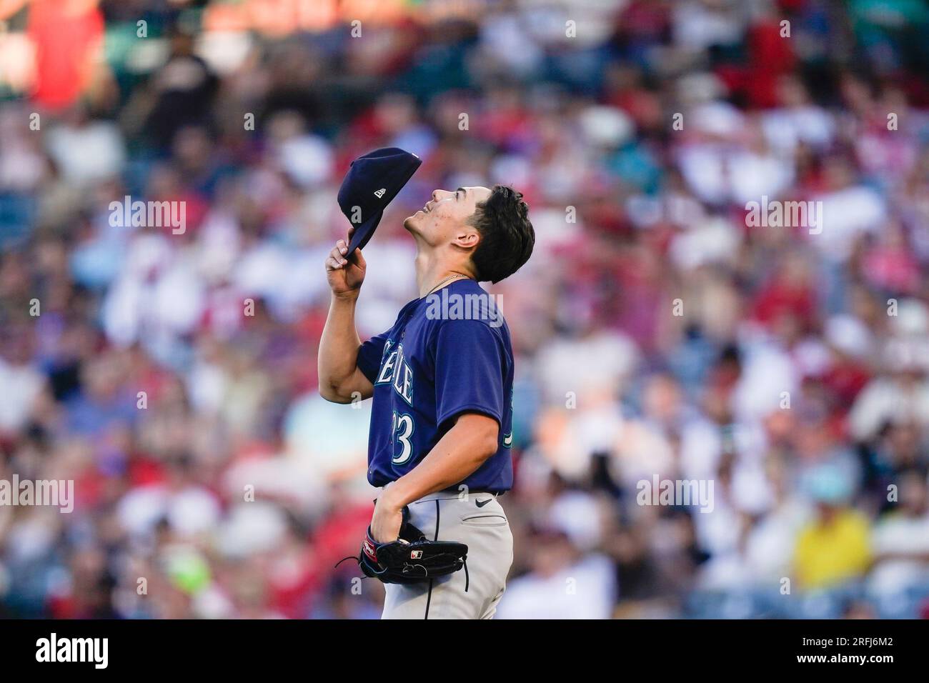 Seattle Mariners starting pitcher Bryan Woo looks up before taking the ...