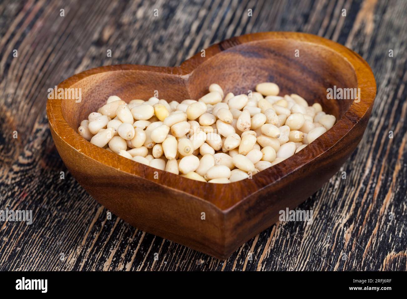 peeled pine nuts of small size, useful nuts, a part of the shell ...