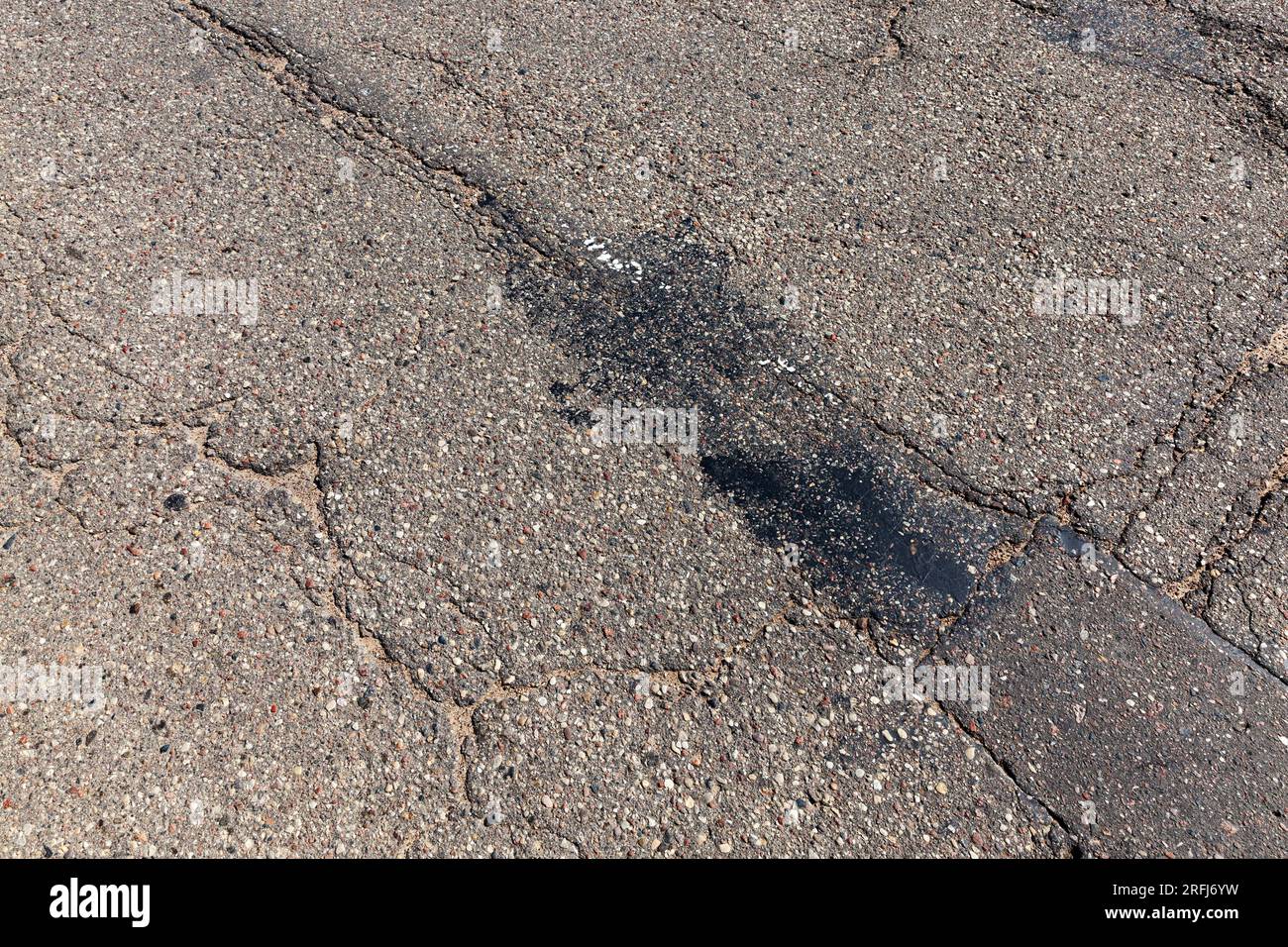 paved road with a lot of holes and potholes, poorly made and dangerous ...