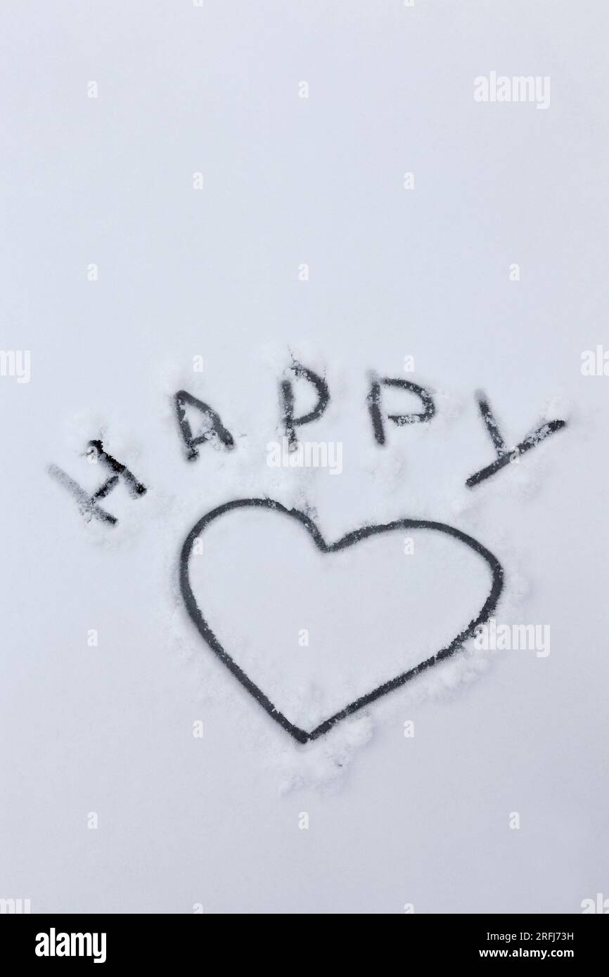 drawn symbol of the heart and the words happy in the snow in the winter ...