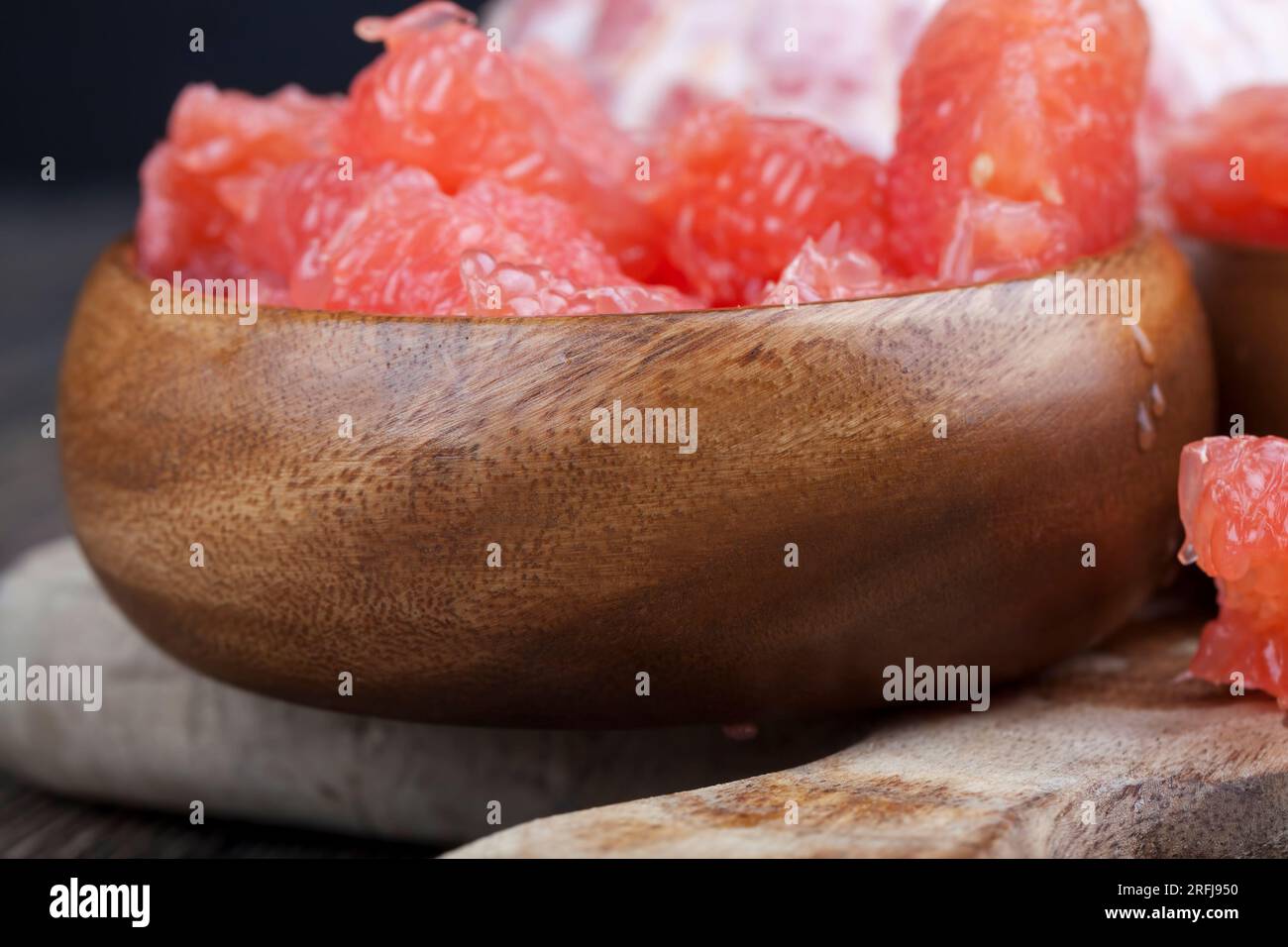 peeled pink grapefruit split into pieces while cooking, ready to eat ...