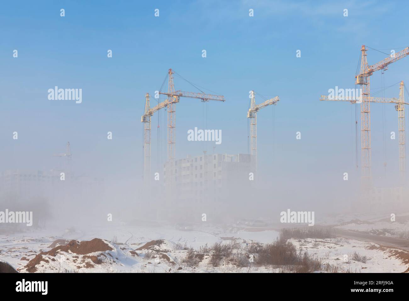 construction cranes on a construction site in winter, a construction ...