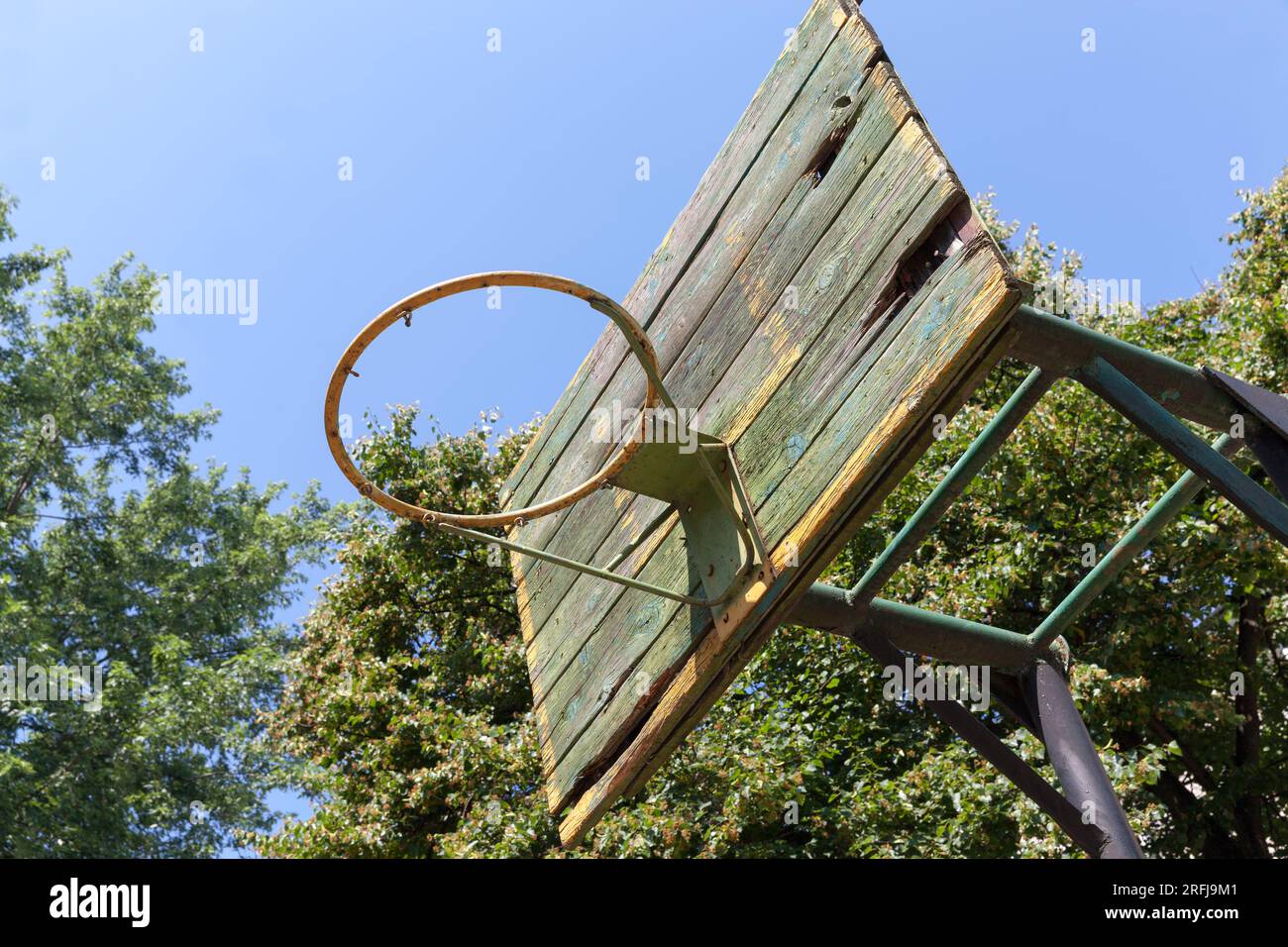 an old basketball ring in the yard, an old wooden shield and a ...