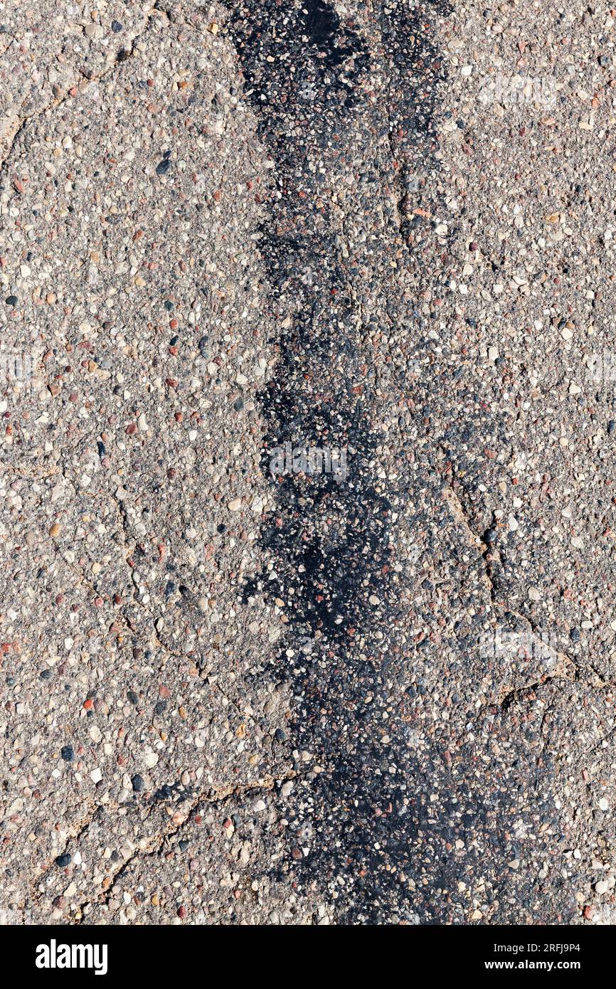 repair of a broken and damaged paved road, the road has many defects ...