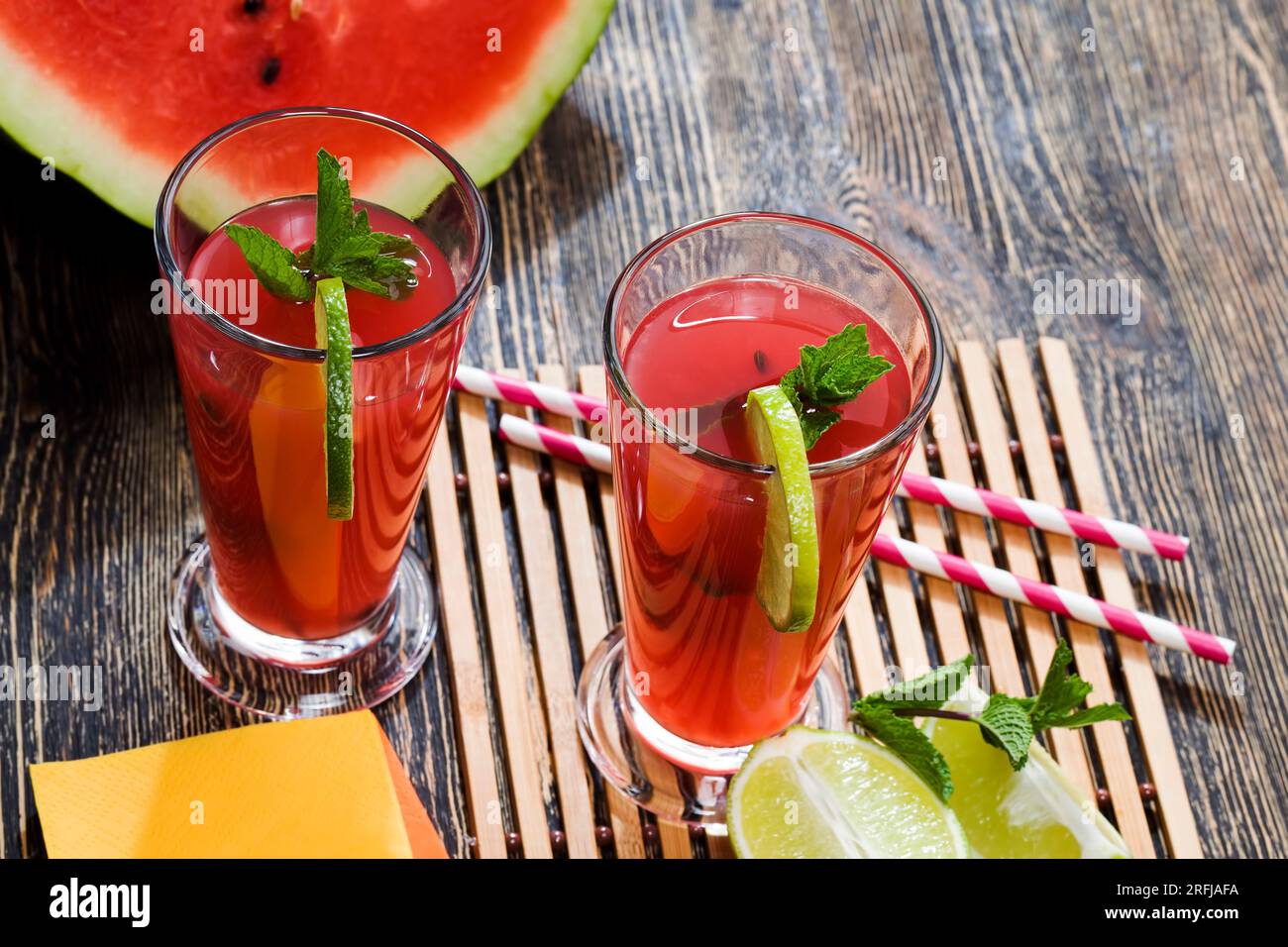 a table with food and red ripe watermelons, from which a delicious and ...