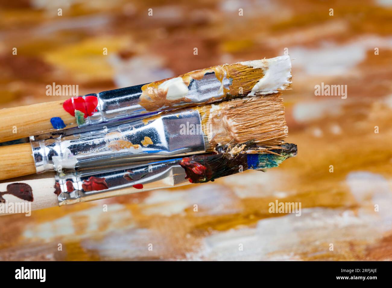 art brushes smeared in paints of different colors after drawing ...