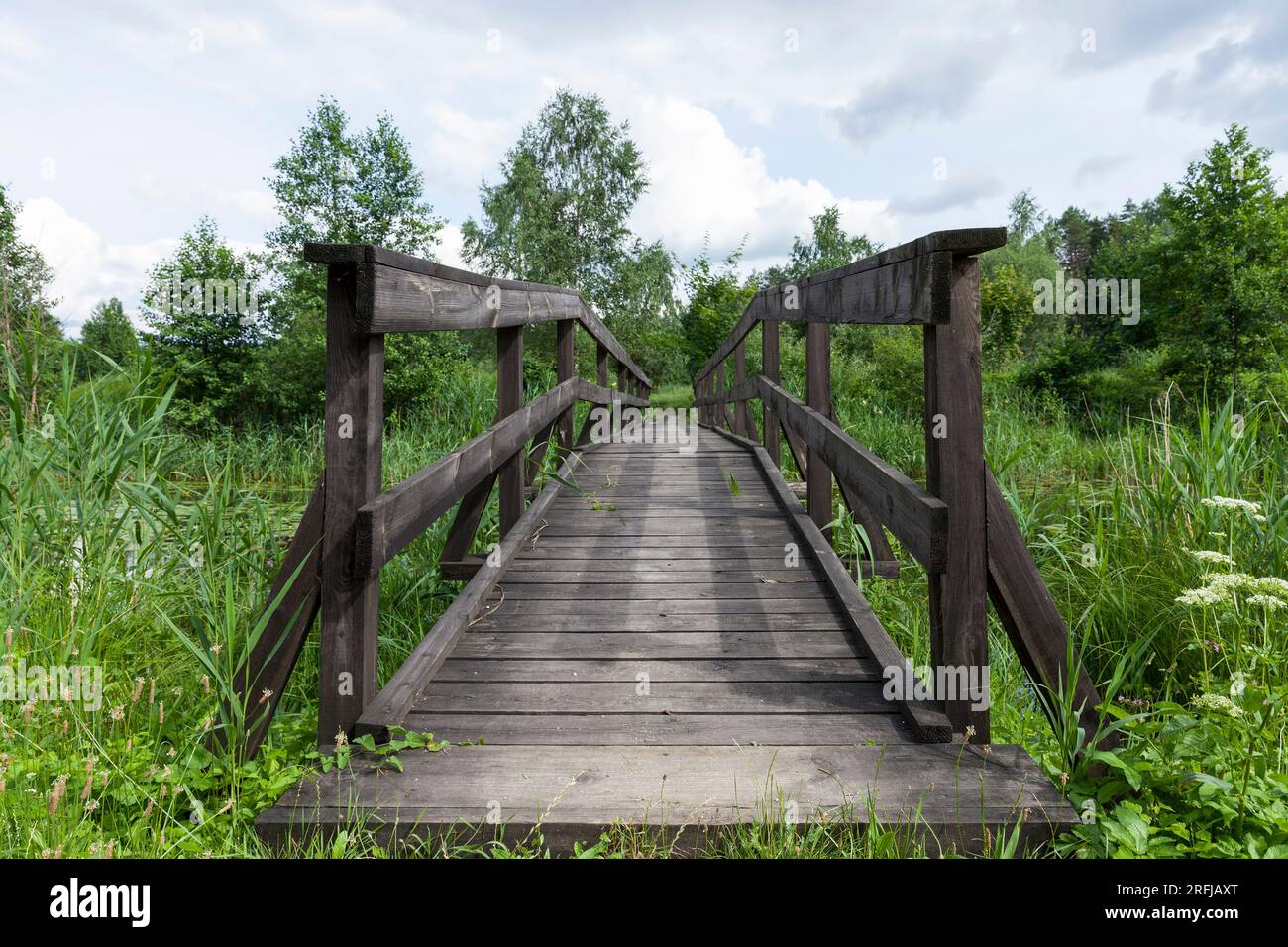 old wooden bridge built on the lake, a bridge between small islands on ...