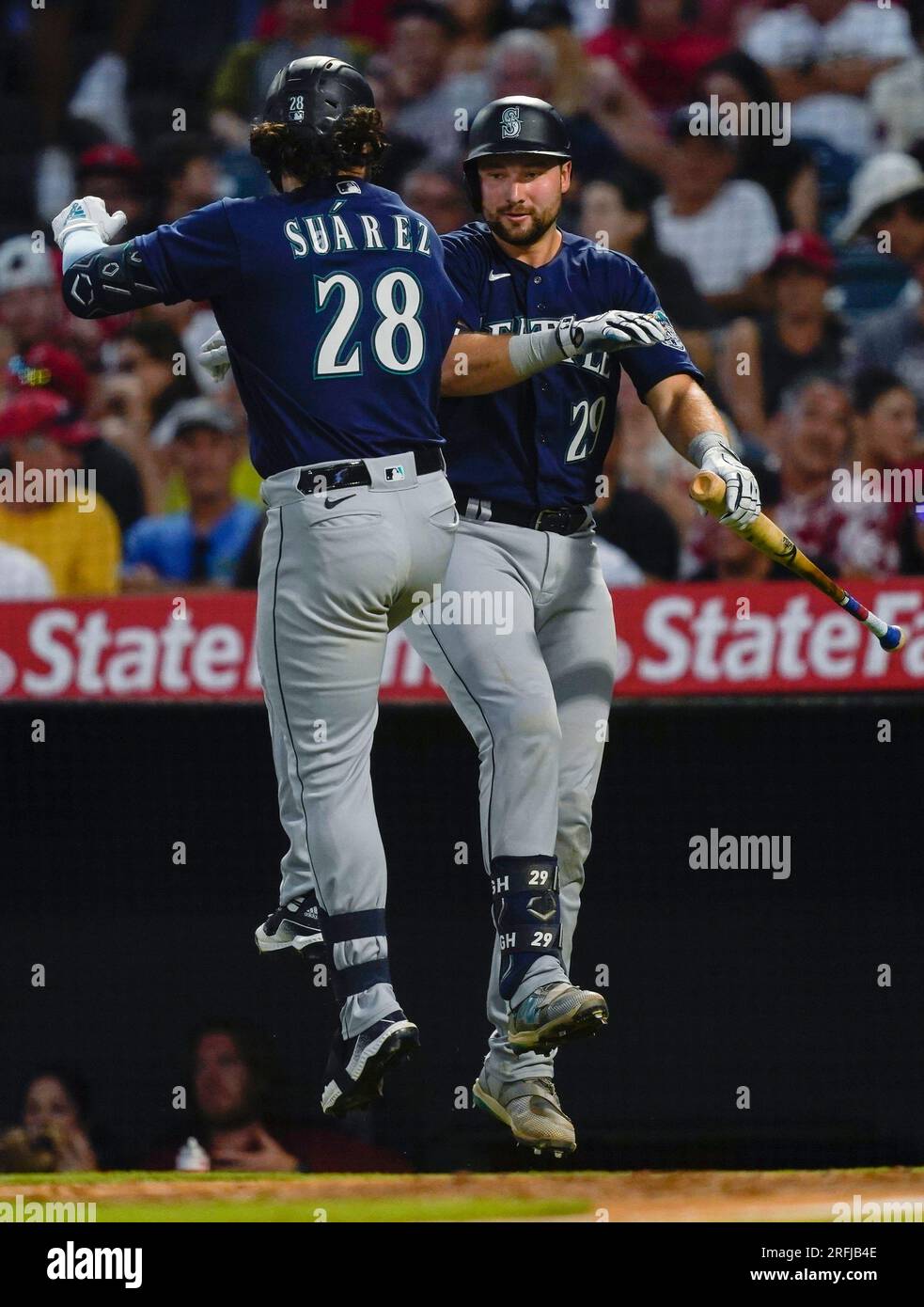 Seattle Mariners' Eugenio Suarez (28) celebrates with Cal Raleigh (29 ...