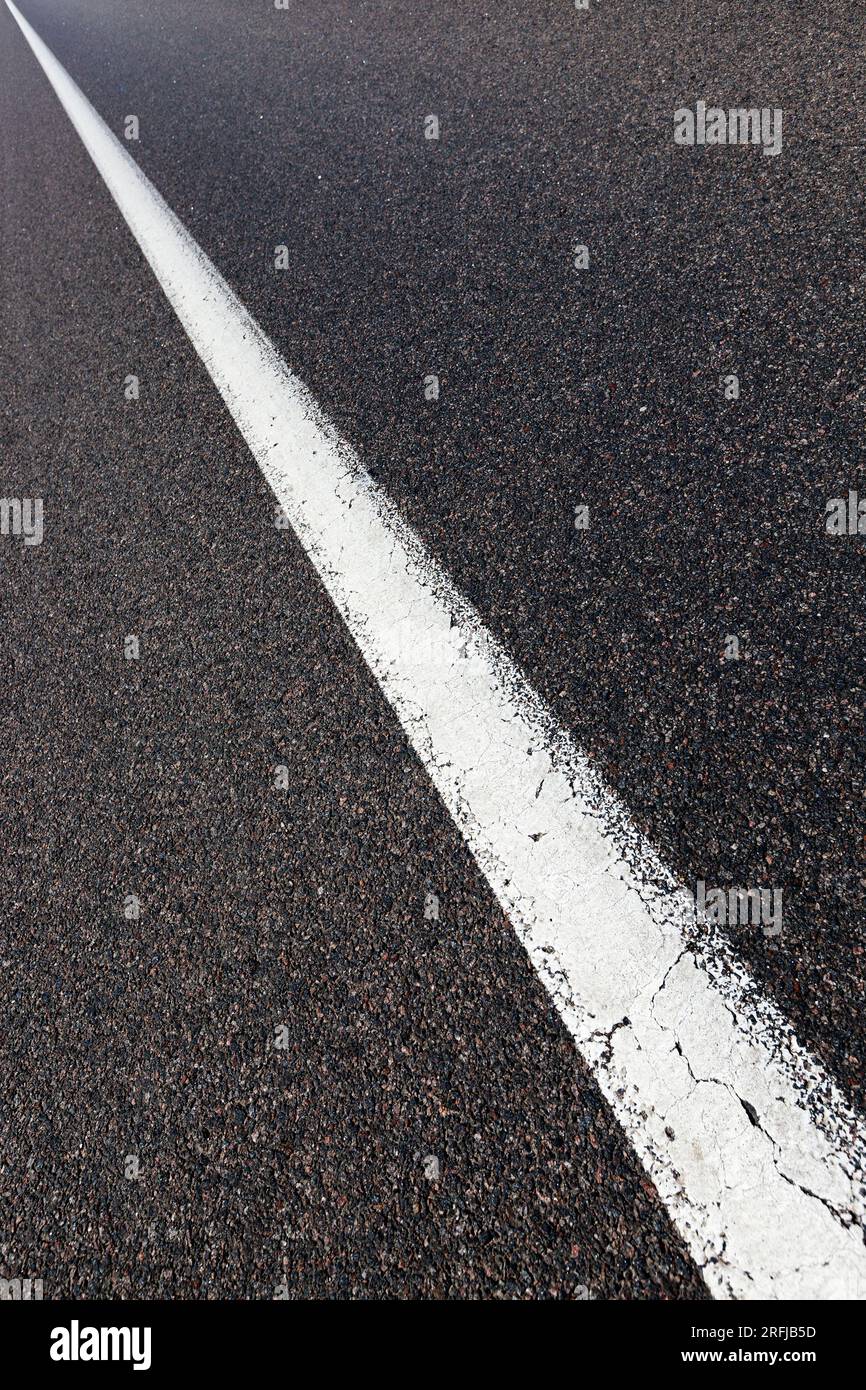 painted with white paint automobile road markings, paved road with ...