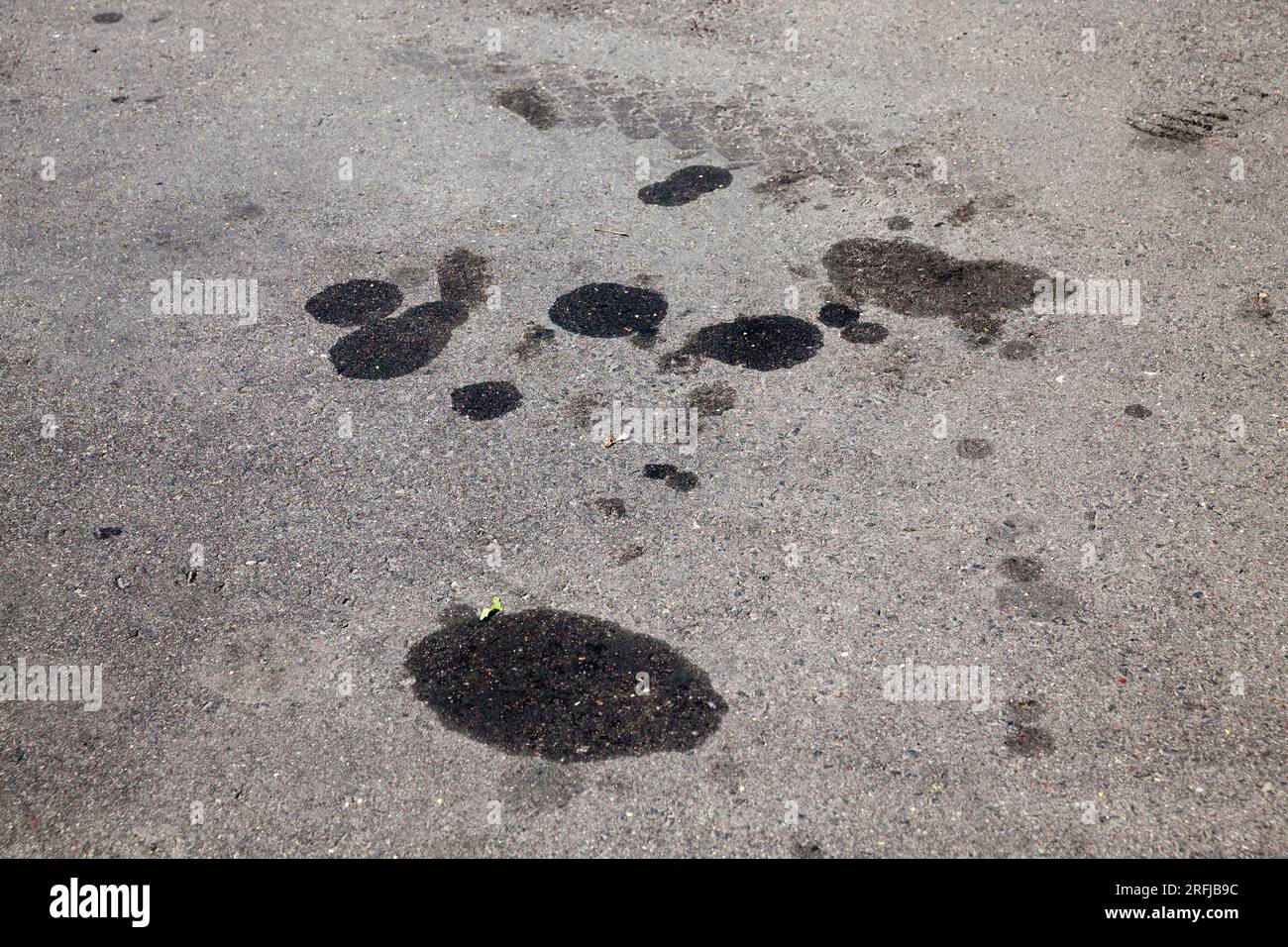 stains from engine oil flowing out of cars, car oil stains on an ...