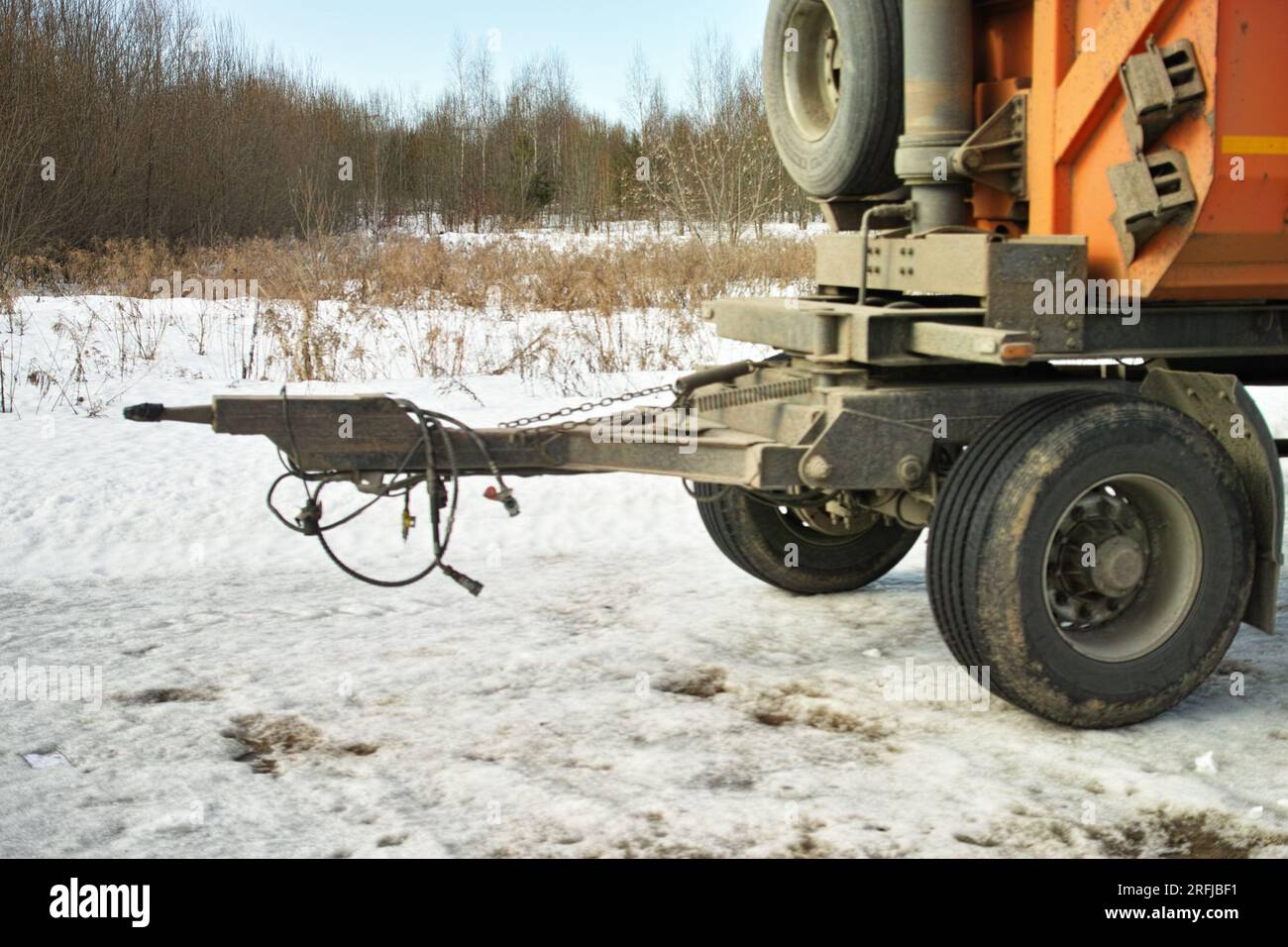 an abandoned trailer with disconnected hitch, winter scene, focus in ...