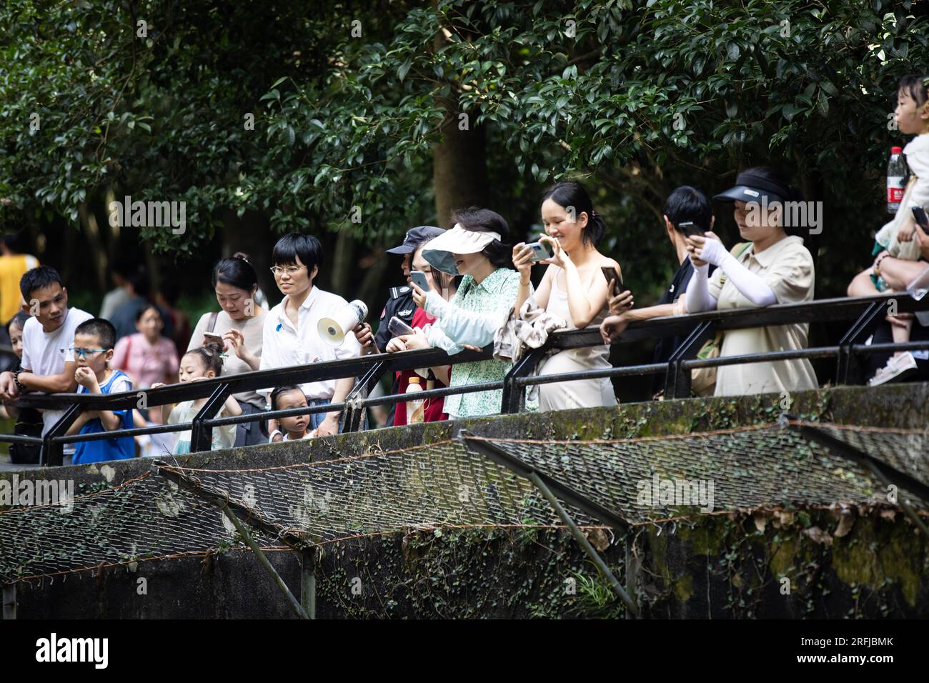 Many people come to watch the Malayan sun bear who can stands upright ...