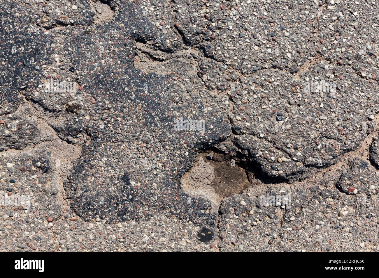 an asphalt road with a lot of holes and potholes, a poorly made asphalt ...