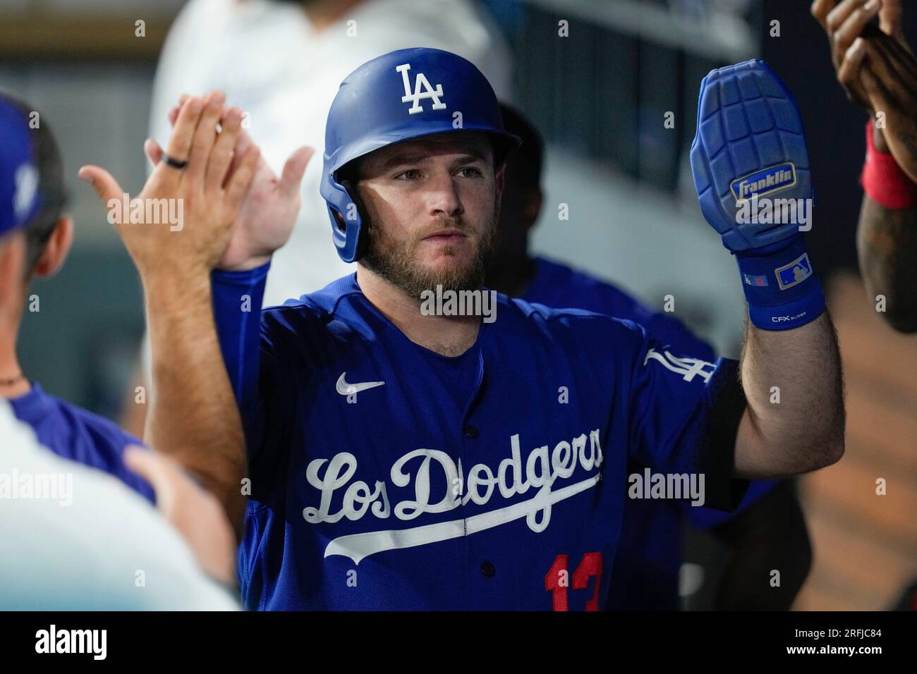 Los Angeles Dodgers' Max Muncy (13) celebrates in the dugout after ...