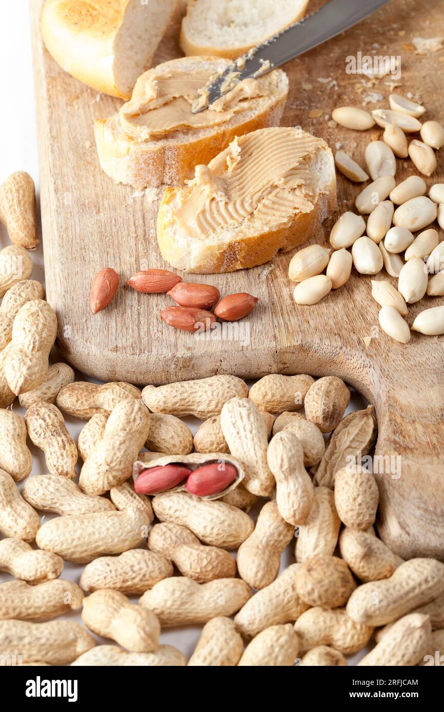 delicious peanut butter and white bread on the table, ingredients for ...