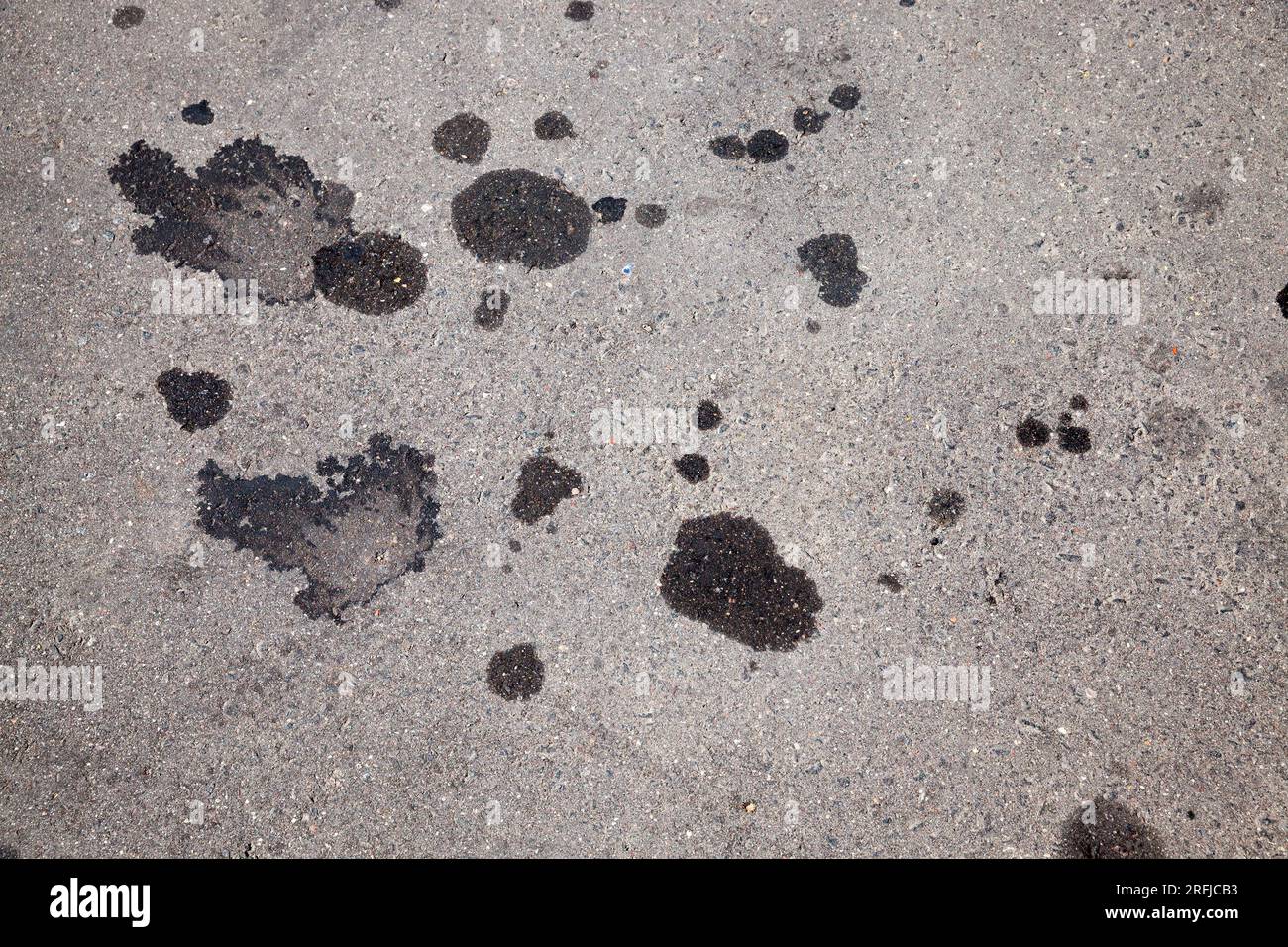 car oil stains on an asphalt road, stains from engine oil flowing out ...
